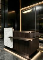 China Luxury Fluted Bronze Reception Counter with Marble Side Panel and Base LED Light for High-End Hotels for sale