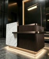 China Luxury Fluted Bronze Reception Counter with Marble Side Panel and Base LED Light for High-End Hotels for sale