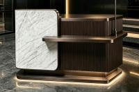China Luxury Fluted Bronze Reception Counter with Marble Side Panel and Base LED Light for High-End Hotels for sale