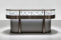China Custom Oval Tempered Glass Jewelry Island Display Counter with Stainless Steel Frame and LED Lighting for Boutique Jewelry Shop for sale