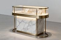 China Oval Curved Glass Jewelry Showcase Table with Brushed Gold Frame and Lockable Storage for sale