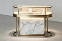 China Oval Curved Glass Jewelry Showcase Table with Brushed Gold Frame and Lockable Storage for sale