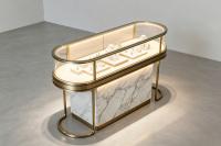 China Oval Curved Glass Jewelry Showcase Table with Brushed Gold Frame and Lockable Storage for sale