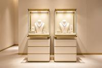 China Tall Wall-Mount Jewelry Display Cabinet with Brushed Gold Frame and Drawer Base for Luxury Jewelry Boutiques for sale