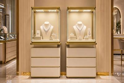 China Tall Wall-Mount Jewelry Display Cabinet with Brushed Gold Frame and Drawer Base for Luxury Jewelry Boutiques for sale