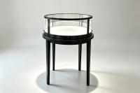 China Minimalist Round Jewelry Display Table with Tempered Glass Showcase and Matte Black Metal Stand Featuring Built-in LED Lighting for sale
