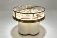 China Custom Luxury 2-Compartment Jewelry Island Showcase with Lockable Circular Glass and Brushed Gold Metal Frame for sale