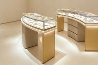 China Luxury Curved Tempered-Glass Jewelry Display Counter with Built-in LED Light and Leather-Wrapped Panel for sale