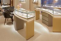 China Luxury Curved Tempered-Glass Jewelry Display Counter with Built-in LED Light and Leather-Wrapped Panel for sale