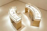 China Luxury Curved Tempered-Glass Jewelry Display Counter with Built-in LED Light and Leather-Wrapped Panel for sale