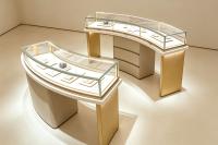 China Luxury Curved Tempered-Glass Jewelry Display Counter with Built-in LED Light and Leather-Wrapped Panel for sale