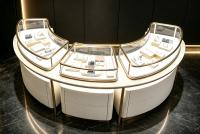 China Combined Curved Jewelry Island Showcase with Champagne Gold Frame and Modular Structure for sale