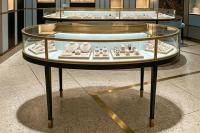 China Luxury Round Jewelry Island Counter with Full-Circle Bent Tempered-Glass and Brushed Gold Metal Frame Featuring Built-In LED Lighting for sale