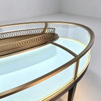 China Luxury Round Jewelry Island Counter with Full-Circle Bent Tempered-Glass and Brushed Gold Metal Frame Featuring Built-In LED Lighting for sale