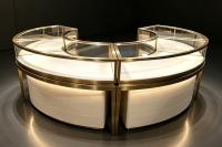 China C-Shaped Curved Jewelry Island Showcase with Brushed Gold Frame and Leather-Wrapped Base Display Counter for sale
