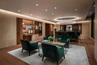China Modern-Luxury Minimalist Watch Showcase Display with Circular Wood Island and VIP Lounge & Bar Area for sale