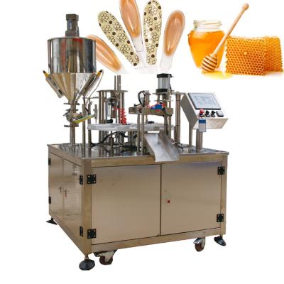 China Honey Spoon Filling Sealing Machine 220V 800-1000 Cups per Hour Automatic Piston Filler for sale