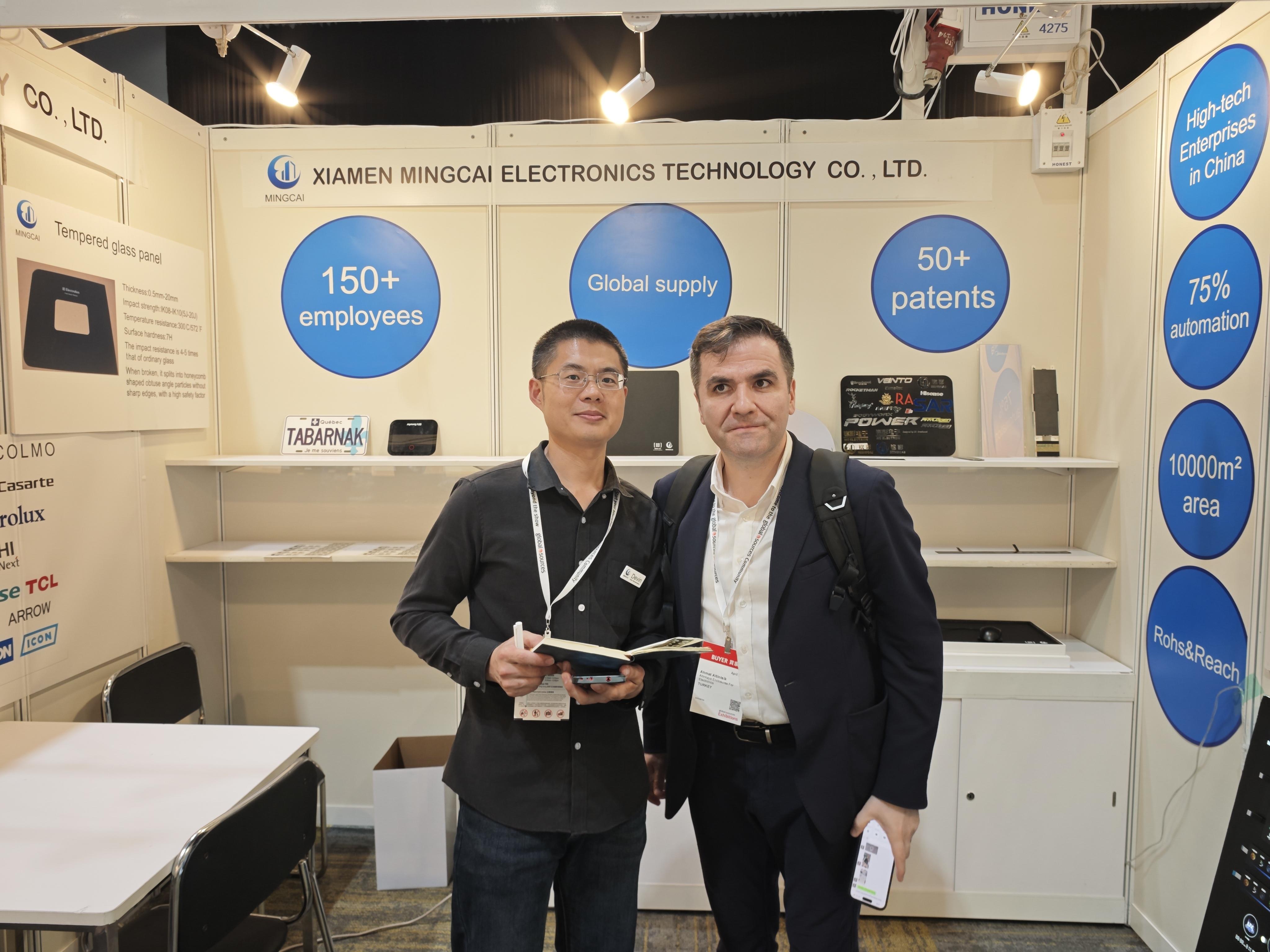 Xiamen Mingcai exhibition booth display showing custom membrane switches, metal nameplates and adhesive labels for industrial, home appliance, medical and fitness equipment