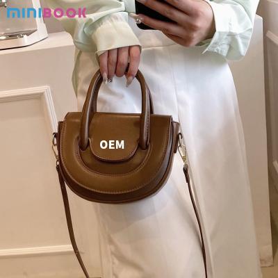 China Solid Color Cowhide Leather Saddle Bag Small Portable Crossbody Zipper Closure 20cm for sale