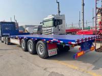 China 60T 3/4 Axles Transfer Container Steel Flatdeck Truck Trailer for High Capacity Cargo for sale