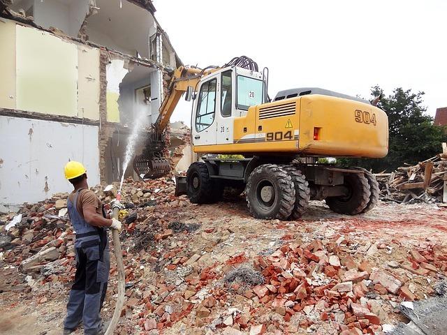 Wheeled excavator on paved road in city