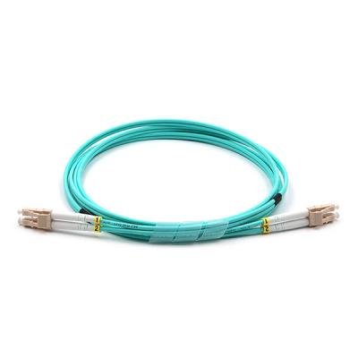 China Indoor LC UPC to LC UPC Fiber Optic Patch Cable Duplex Armored OM3 Multimode LSZH 3.0mm Aqua 10Gbps 300m for sale