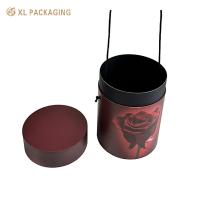 China Luxury Rose Flower Paper Tube Box with Custom Rose Artwork Black Rope Handle and Burgundy Red Matte Finish for sale