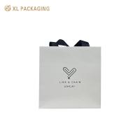 China XL Packaging Custom Packaging Factory Customized Luxury Printing Paper Bag Gift Paper Packaging Paper Bag with the Custom Logo Cloth Package Shipping Bag for sale
