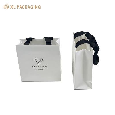 China XL Packaging Custom Packaging Factory Customized Luxury Printing Paper Bag Gift Paper Packaging Paper Bag with the Custom Logo Cloth Package Shipping Bag for sale