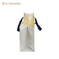 China XL Packaging Custom Packaging Factory White Paper Packaging Bags Gold Foil Kraft Paper Clothes Shoes Shopping Bag With Handle for sale