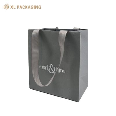China Luxury Gray Paper Gift Bag with Custom Logo, Textured Heavy-Duty Cardstock and Ribbed Fabric Handles for Boutique Packaging for sale