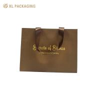 China Luxury Paper Gift Bag with Gold Foil Hot Stamping, Wide Satin Ribbon Handles, and Triangular Foldable Bottom for sale