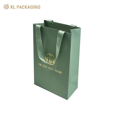 China XL Packaging Custom Packaging Factory Custom Design Printed Shopping Gift Packaging Paper Bag With Your Own Logo Luxury Green Ribbon Thick Paper Bag For Clothes for sale