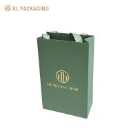 China Custom Gold Foil Logo Matte Sage Green Frosted Art Paper Gift Bag with Color-Matched Wide Satin Ribbon Handles for sale