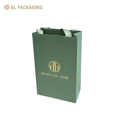 China Custom Gold Foil Logo Matte Sage Green Frosted Art Paper Gift Bag with Color-Matched Wide Satin Ribbon Handles for sale