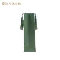 China XL Packaging Custom Packaging Factory Custom Design Printed Shopping Gift Packaging Paper Bag With Your Own Logo Luxury Green Ribbon Thick Paper Bag For Clothes for sale