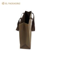 China Custom Gold Foil Stamping Kraft Paper Gift Bag with Matte Satin Ribbon Handles and Reinforced Double Fold Edge for sale