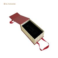 China Custom Magnetic Closure Box Red Yellow Printing Ribbon Handle Foam Insert for sale
