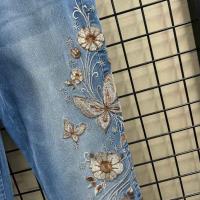 China Women's Bootcut High Waist Flared Jeans Medium Blue Denim Jeans with Heavy Embroidery for sale