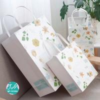 China Custom Printed Paper Shopping Bags 100gsm Kraft Ribbon Handle Eco Friendly for sale