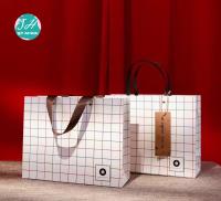 China Custom Printed Paper Shopping Bags 100gsm Kraft Ribbon Handle Eco Friendly for sale