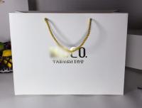 China Custom Printed Paper Shopping Bags 100gsm Kraft Ribbon Handle Eco Friendly for sale