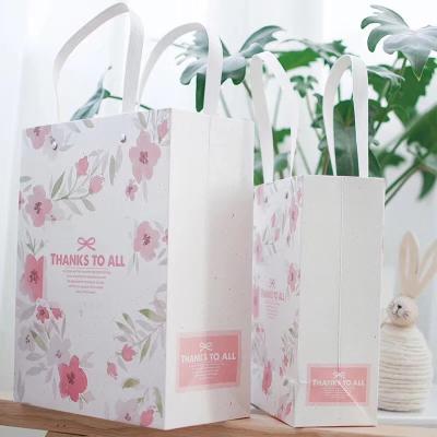 China Custom Kraft Paper Carry Bags 32x11x38cm CMYK Color Luxury Shopping Tote for sale