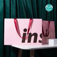 China Luxury Paper Shopping Bags with Bow Tie Ribbon Handle 250gsm Custom Logo for sale