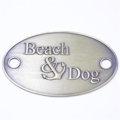 China Customized Zinc Alloy Nameplate Metal Oval Name Plate With Embossed Font Beach Logo for sale