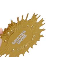 China Gold Sun Burst Pattern Stamped Aluminum Perfume Label With Adhesive Backing for sale