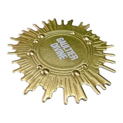 China Gold Sun Burst Pattern Stamped Aluminum Perfume Label With Adhesive Backing for sale