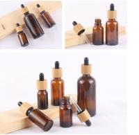 China Glossy Amber Color Bamboo Essential Oil Glass Dropper Bottle Wood Cap Glass Cosmetic Containers for sale
