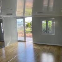 China Expandable Layout Prefab Container House Fiberglass Panels Sleek Yellow Exterior for sale