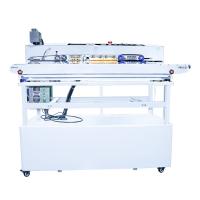 China PLC Control Vertical Band Sealer Machine Laser Coder Foil Film Food Packaging 0-12m/min for sale